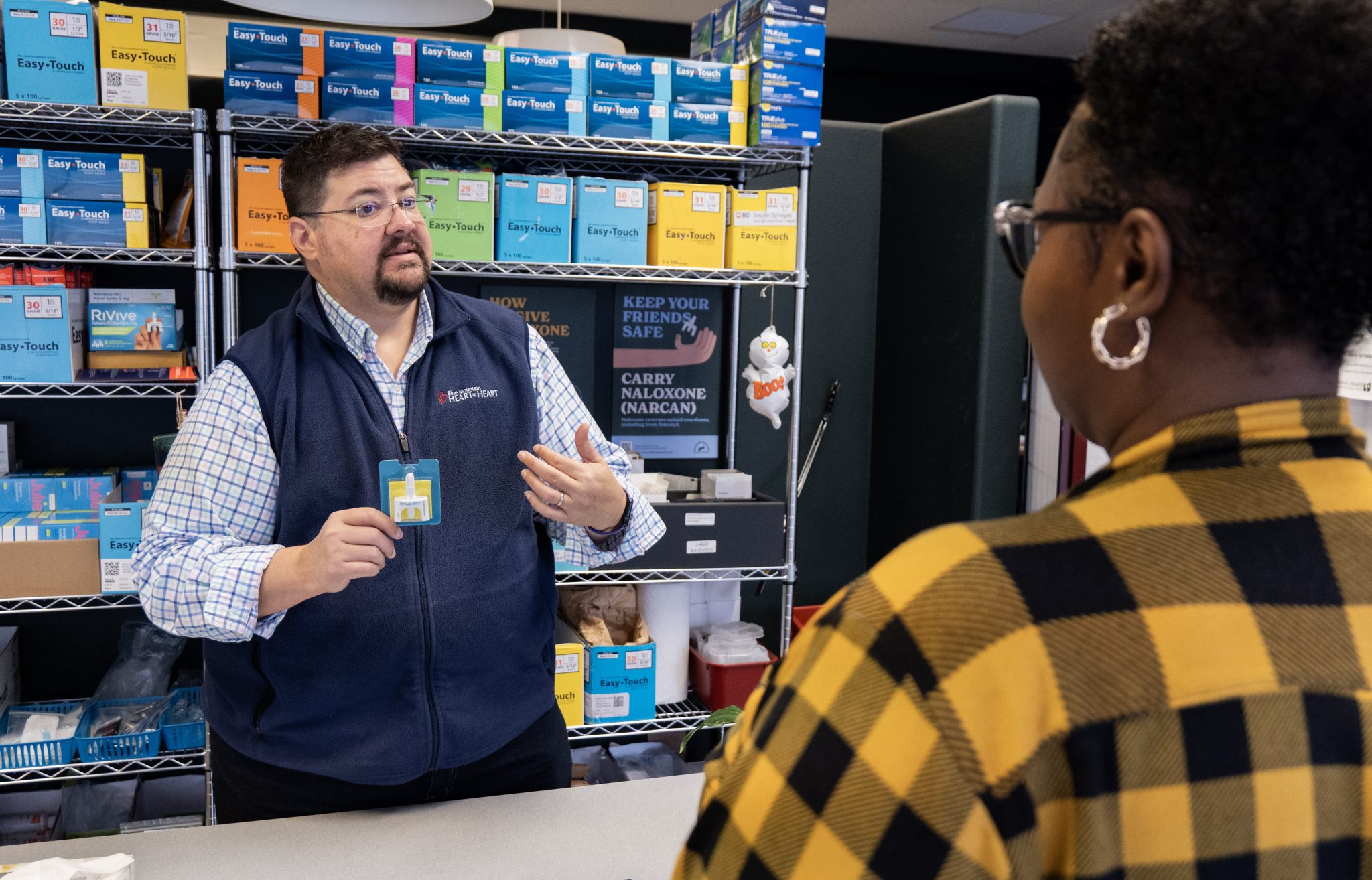 BMH2H067 Syringe services program staff showing client a naloxone nasal ...