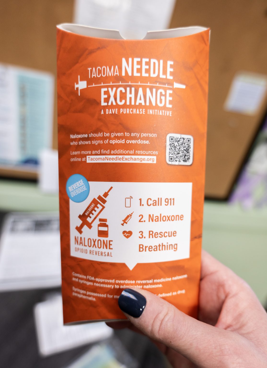 TNE027 Close up of hand holding a naloxone kit – Empathy Lens
