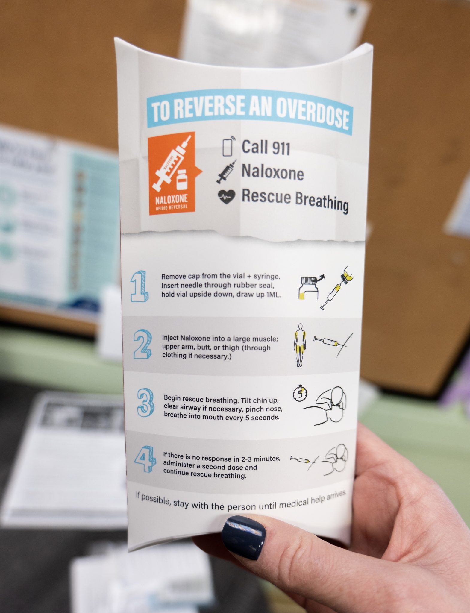 TNE028 Close-up of a hand holding a naloxone kit – Empathy Lens